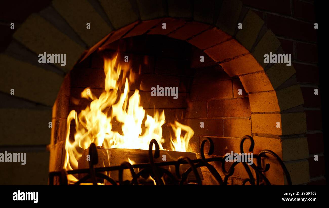 Wood-burning fireplace in the house, close-up. Burning wood-burning ...