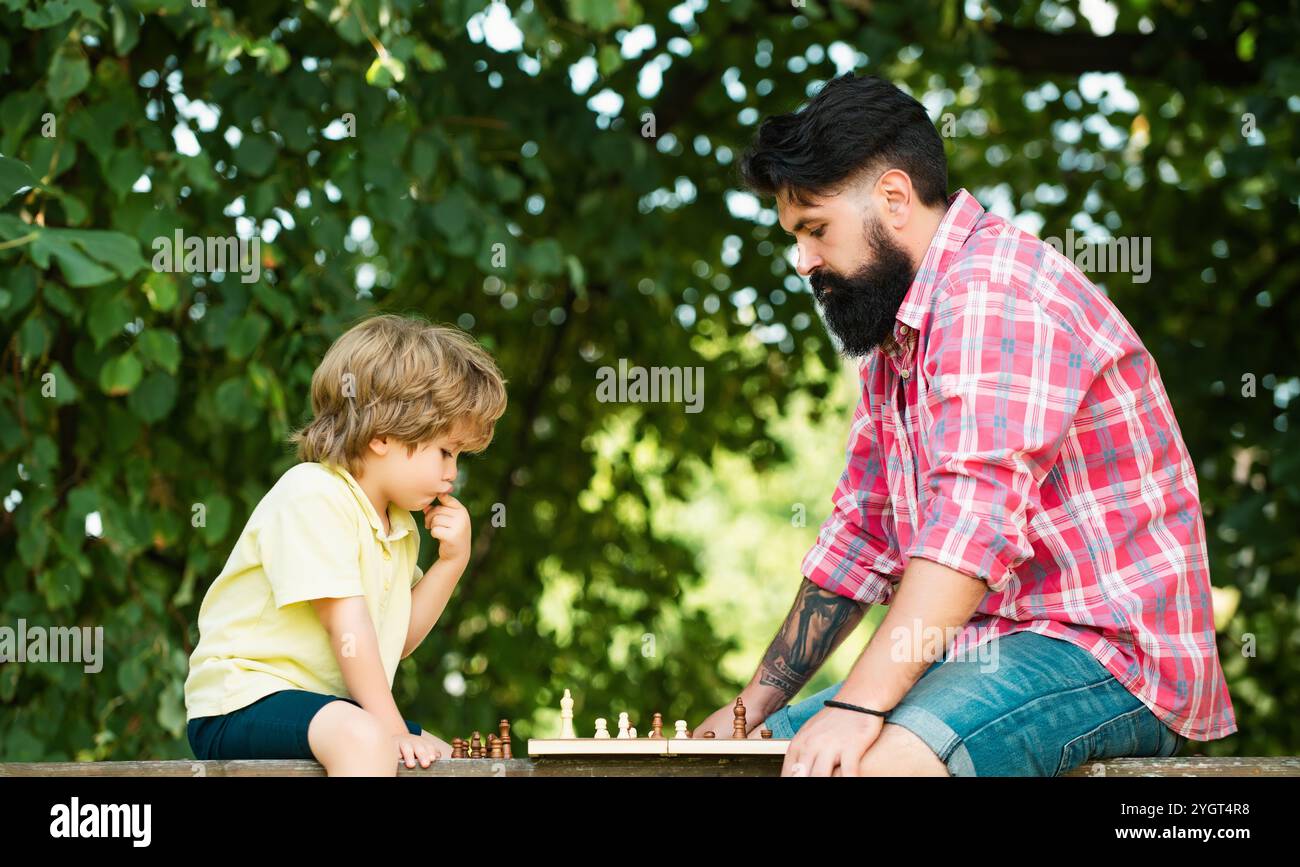 Father and Son Playing Chess. Chess. Father teaching his son to play ...