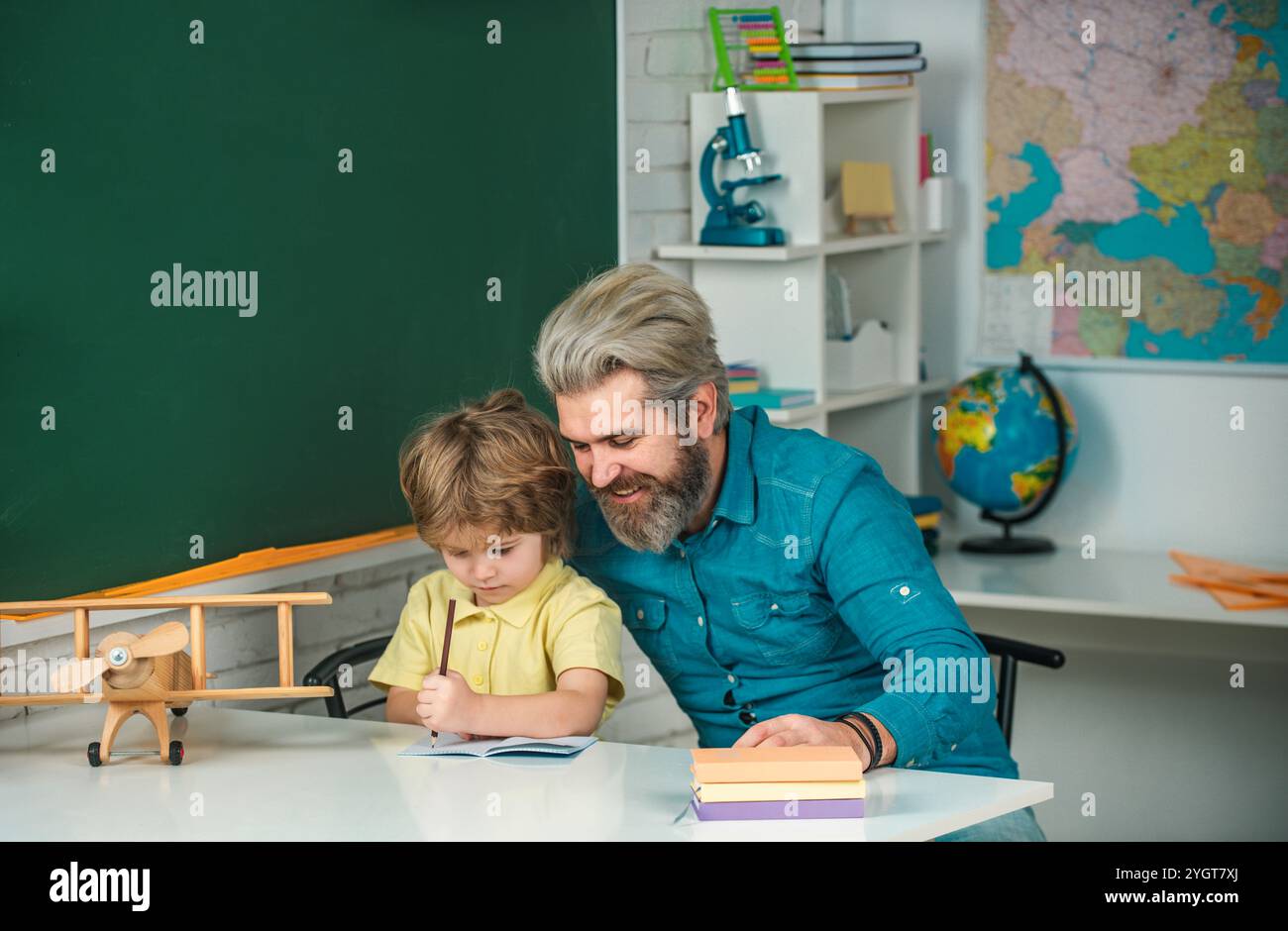 Father helping his son to make homework. Private child tutor. Cute child boy with teacher in ...