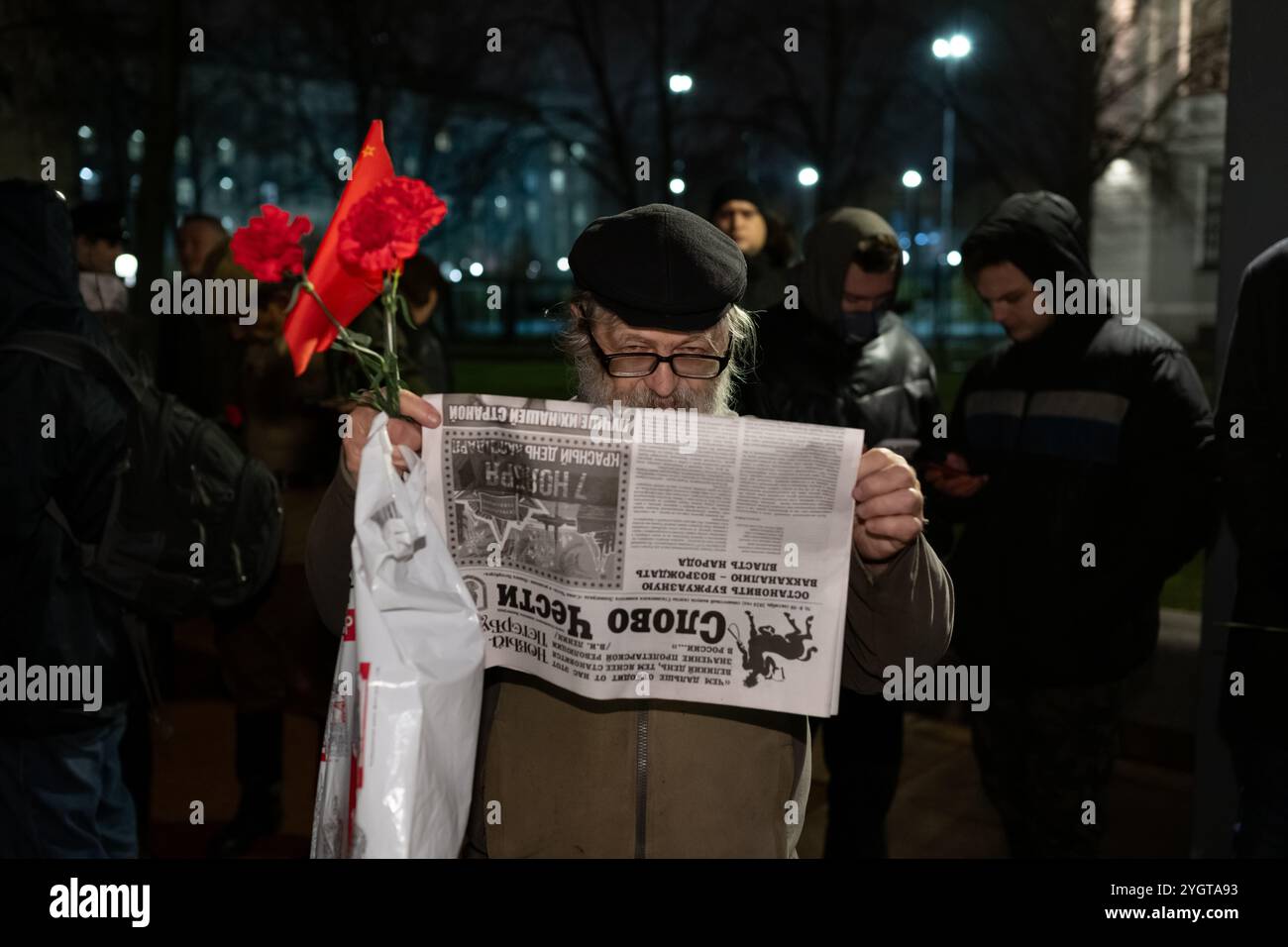 A supporter of the Communist Party reads a newspaper during the ...