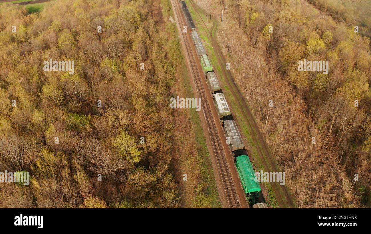 A train with boxcars rides on a railroad top view. A train that carries ...