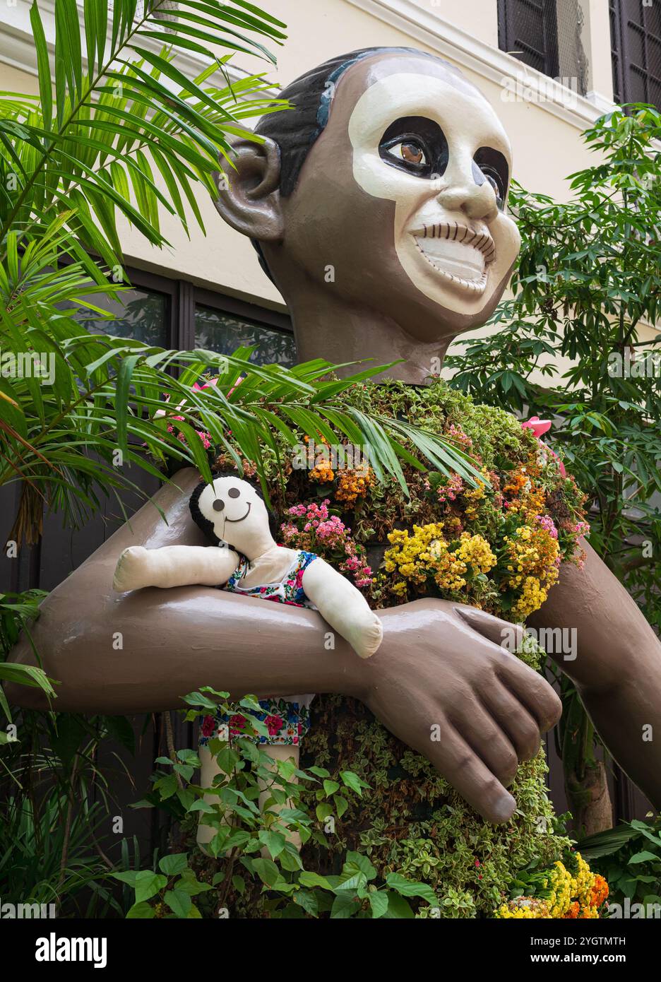 Day of the dead flower sculpture of a Maya child with a skull painted ...