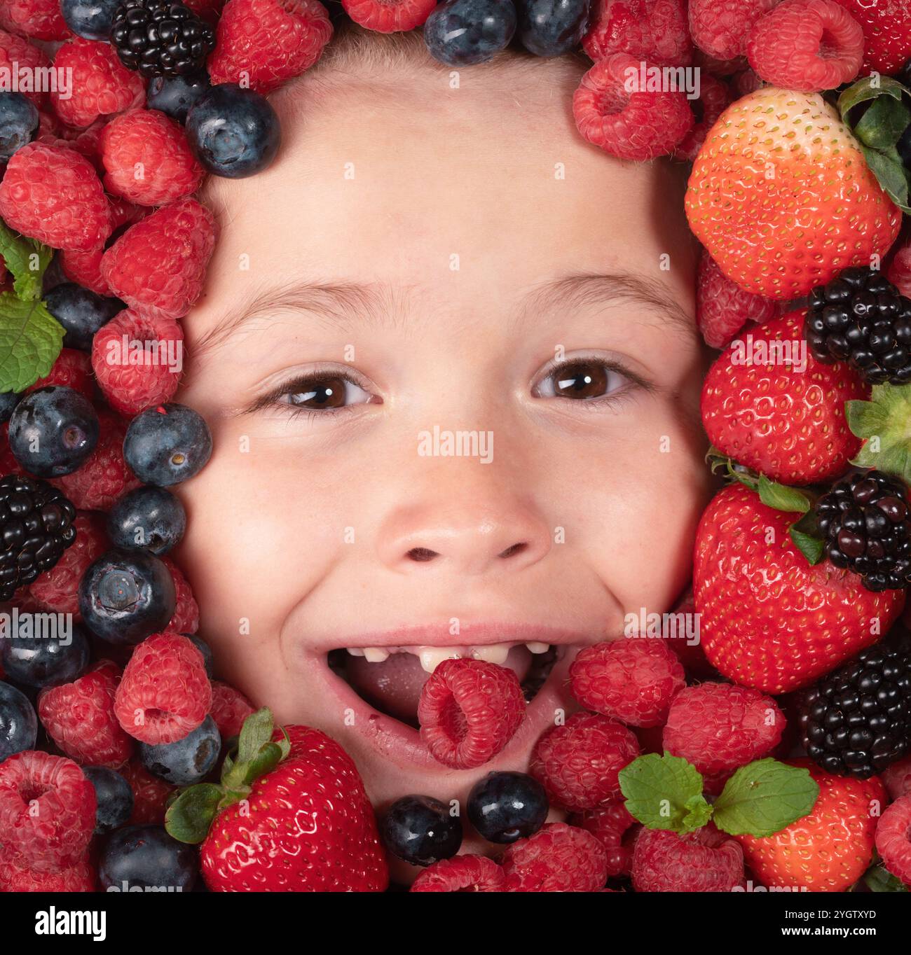 Healthy vitamins fruits. Kids face with berries mix of strawberry ...