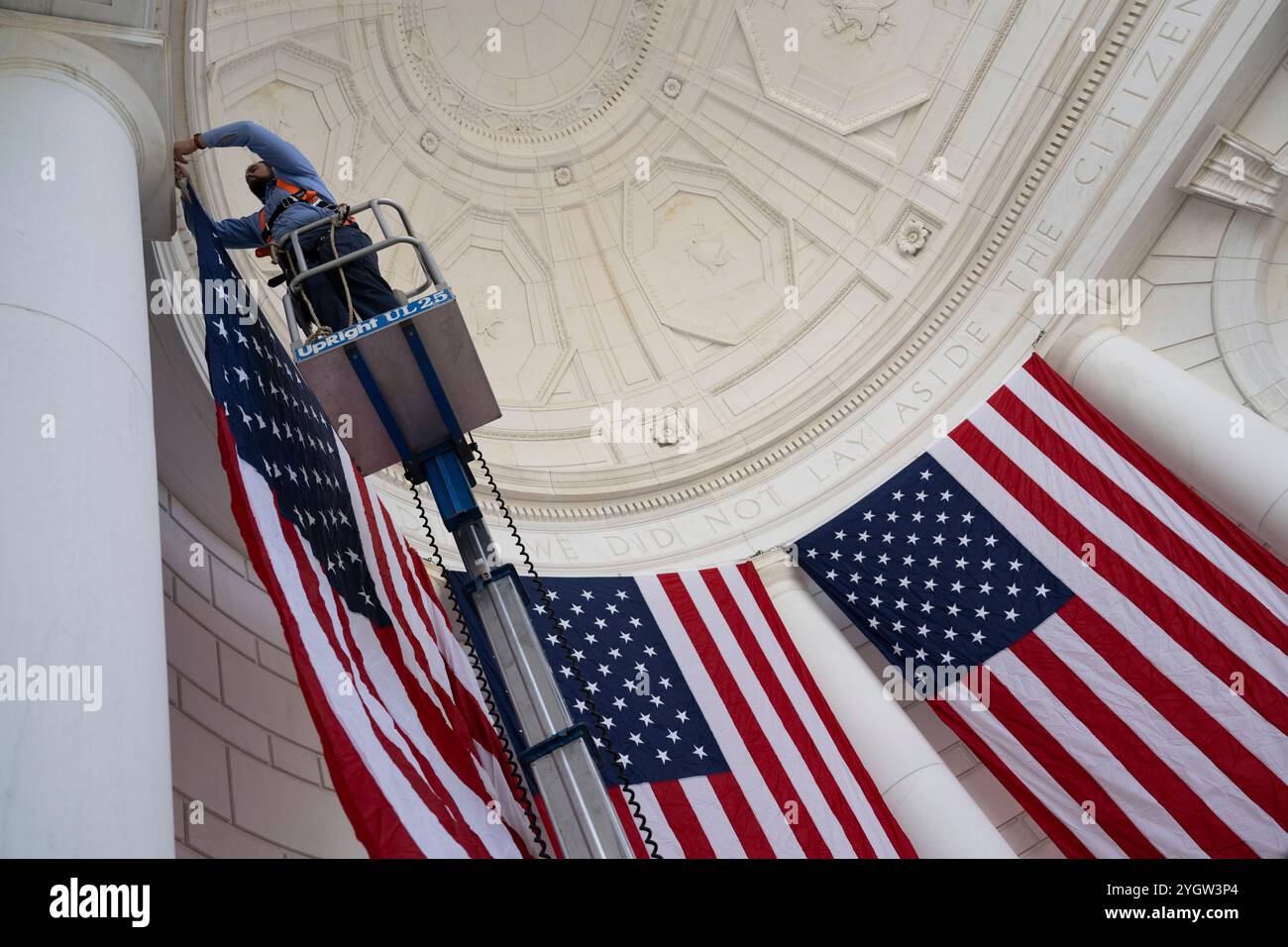 Arlington National Cemetery Facilities Maintenance employees hang U.S ...