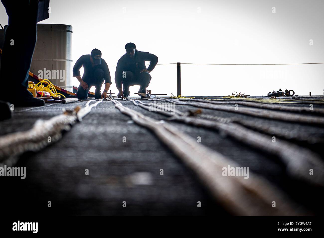 Sailors inventory deck equipment in the hangar bay of the aircraft ...