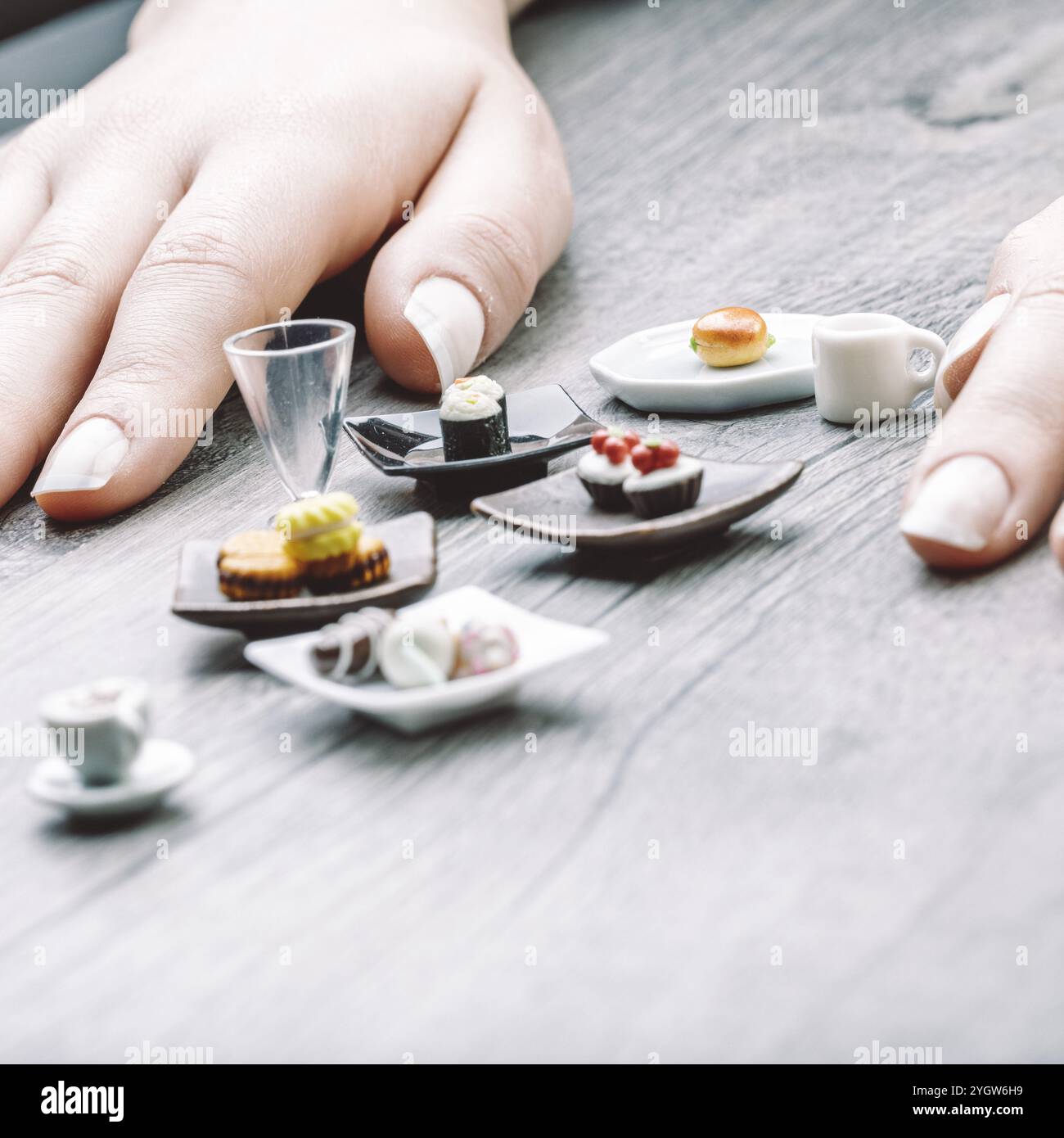 Miniature servings of coffee, pastries, and sushi illustrate portion ...