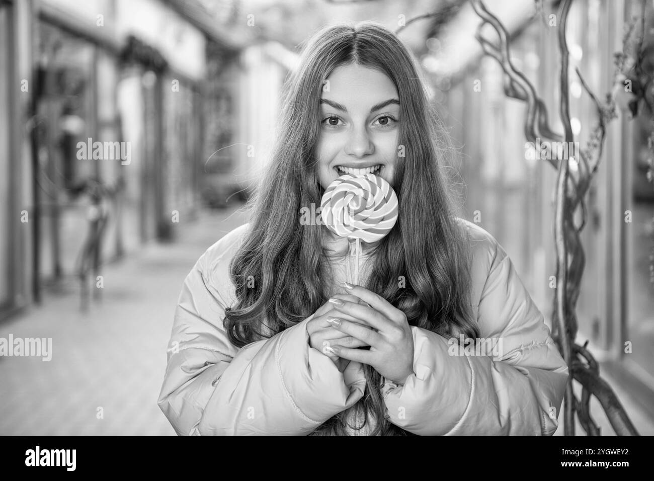 girl eating lollipop candy outdoor. girl with lollipop candy with long ...