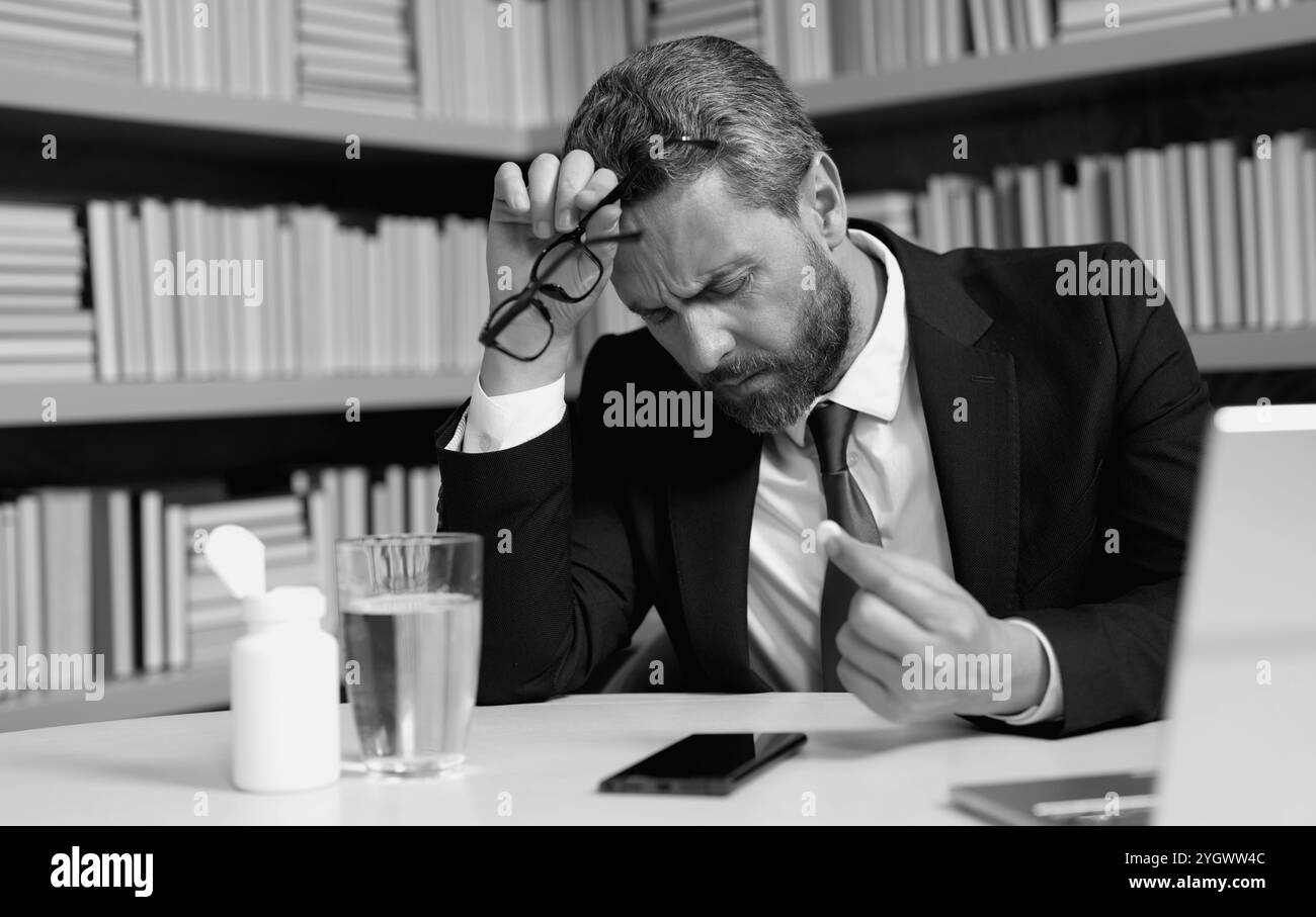 Business man suffering from headache after computer work, exhausted ...