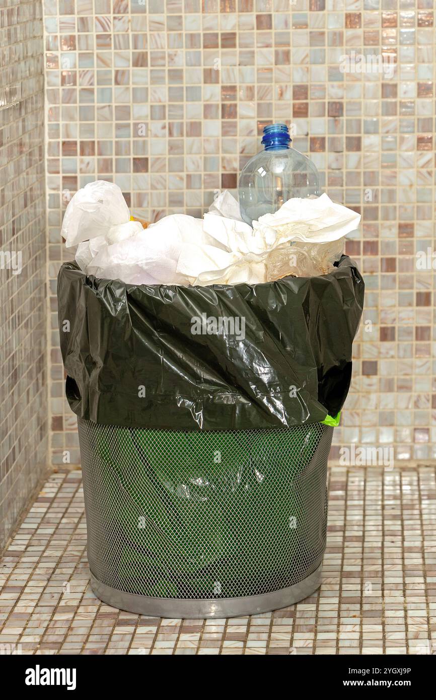 Large pile of garbage inside plastic bag in metal trash bin Stock Photo ...