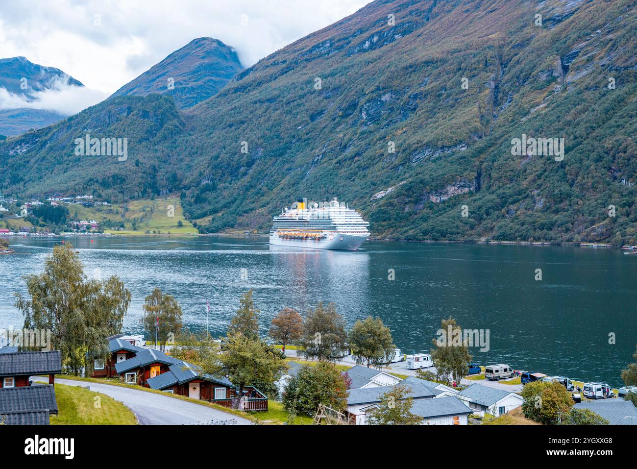 Cruise ship Costa Diadema departs port in Geiranger and travels along ...