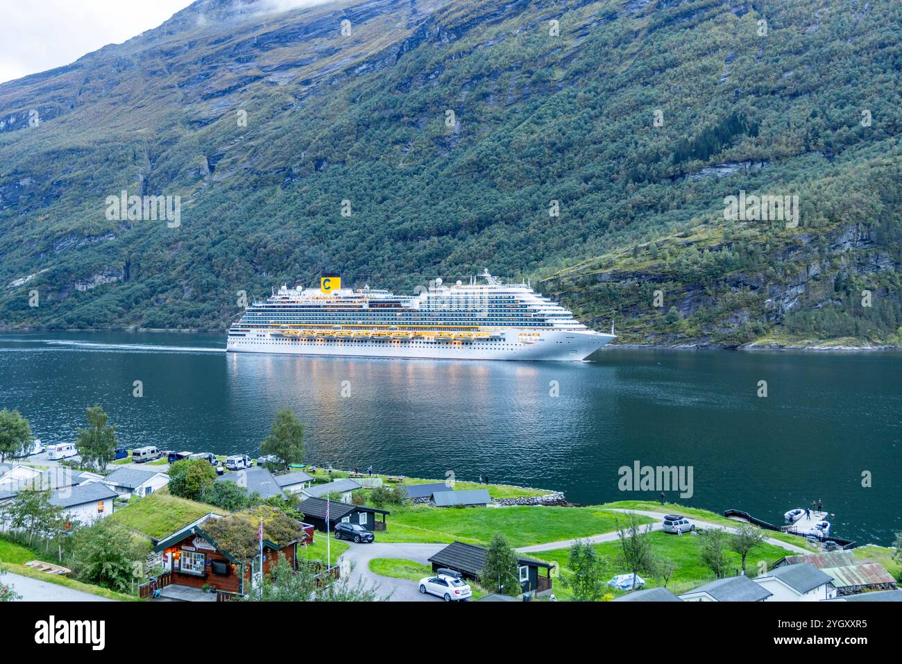 Cruise ship Costa Diadema departs port in Geiranger and travels past ...