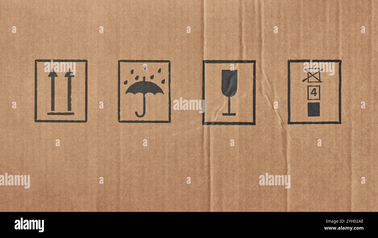 symbols printed on cardboard box, four icons with important handling instructions for safe ...