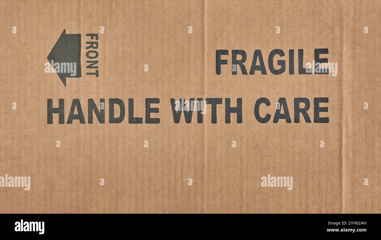 labels printed on cardboard box, front and fragile handle with care, important handling ...