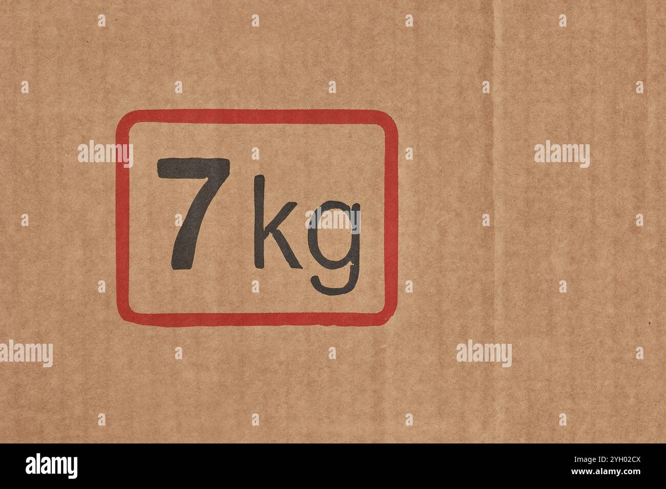 7kg inside red square printed on cardboard box, indicates weight of the ...
