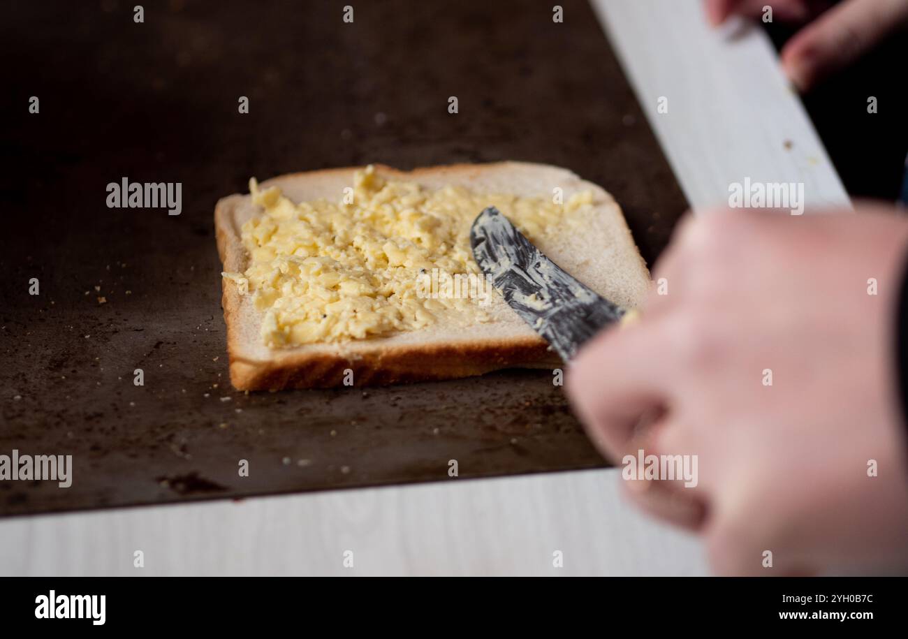 Making cheese rolls iconic new zealand dish cooking grating Stock Photo ...