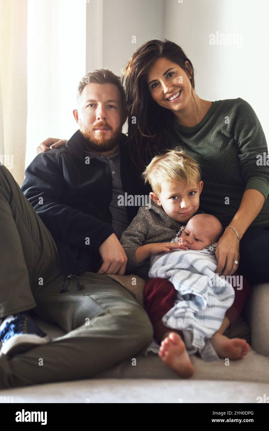 Smile, portrait and parents with children in home with love, care and ...