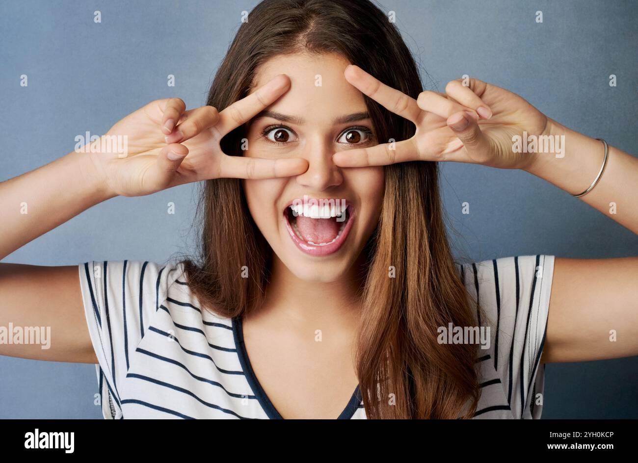 Peace sign, emoji and woman with excited, screaming and confidence in ...