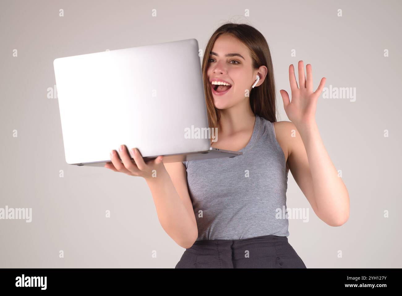 Happy Student. Woman Student in white t-shirt holding laptop and laptop ...