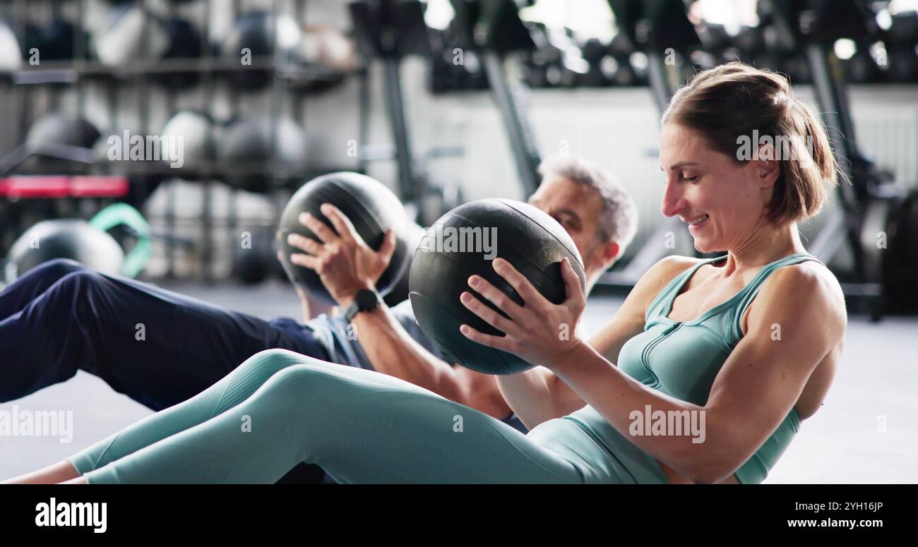 Couple Doing Abdominal Sit Up Workout In Gym. Fit Athletes Stock Photo ...
