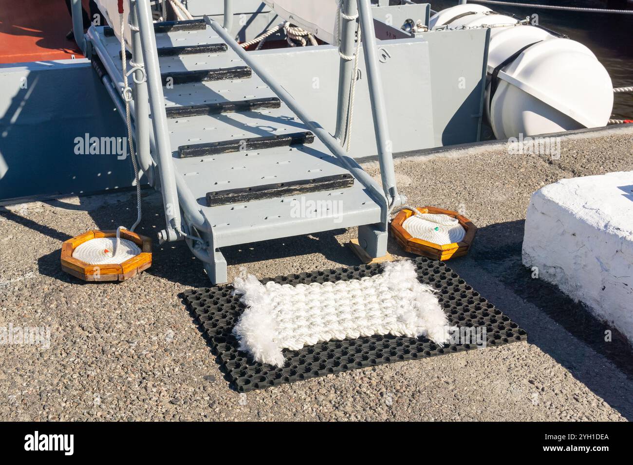 maritime tradition: a snow-white doormat woven from rope in front of ...