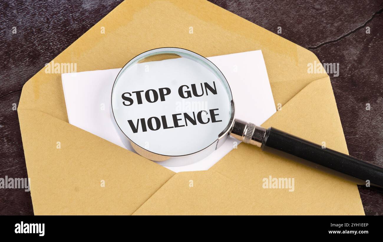 STOP GUN VIOLENCE text written on a blank sheet on a postal envelope ...