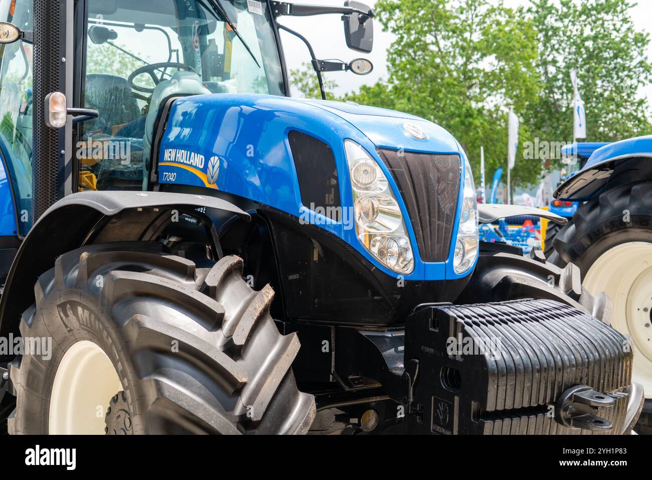 Farm blue tractor of New Holland company at agriculture exhibition ...