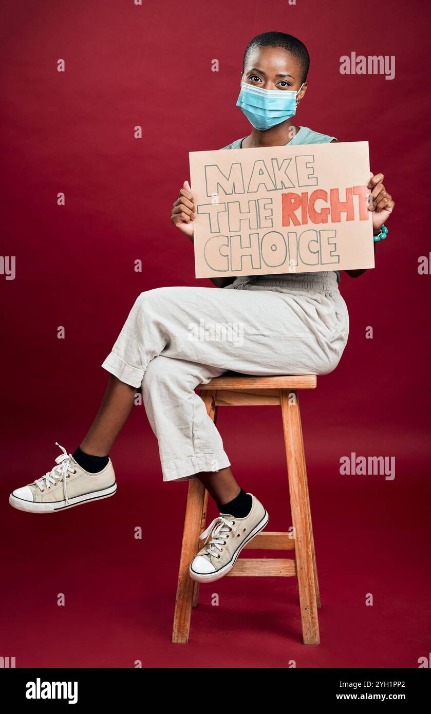 Portrait, face mask and placard with black woman in studio for protest ...