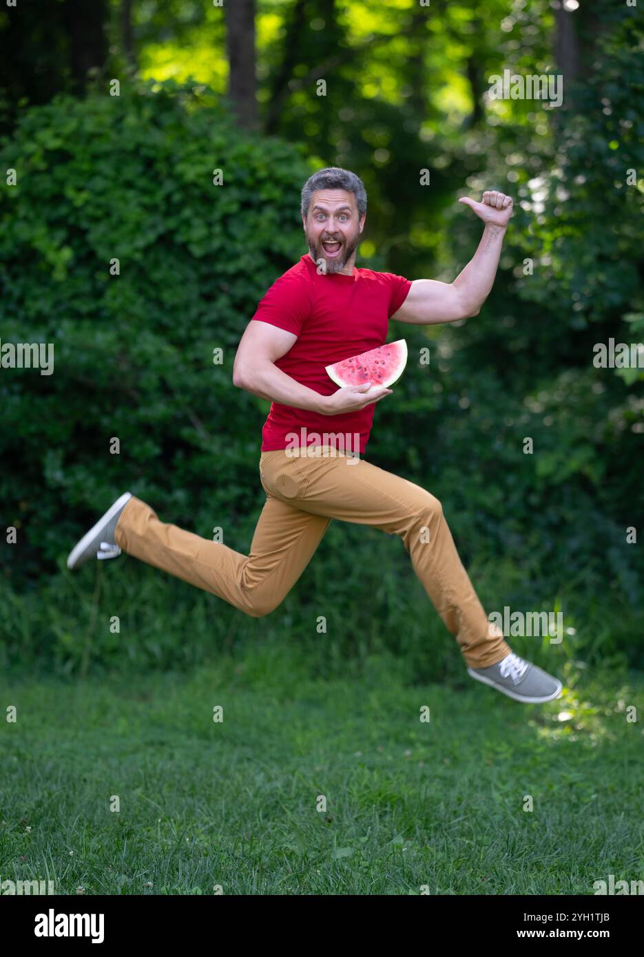 Funny Male face with watermelon, close up. Excited crazy man jump with ...