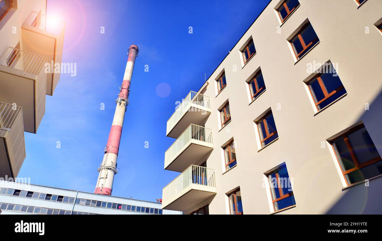 Multi storey building and factory chimney. New multi-storey facade ...