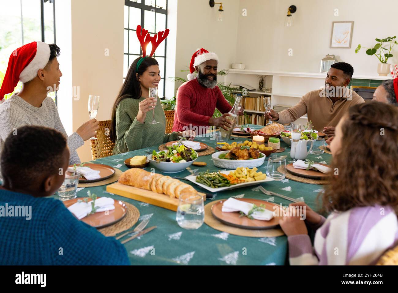multiracial family celebrating Christmas dinner together, sharing joy ...