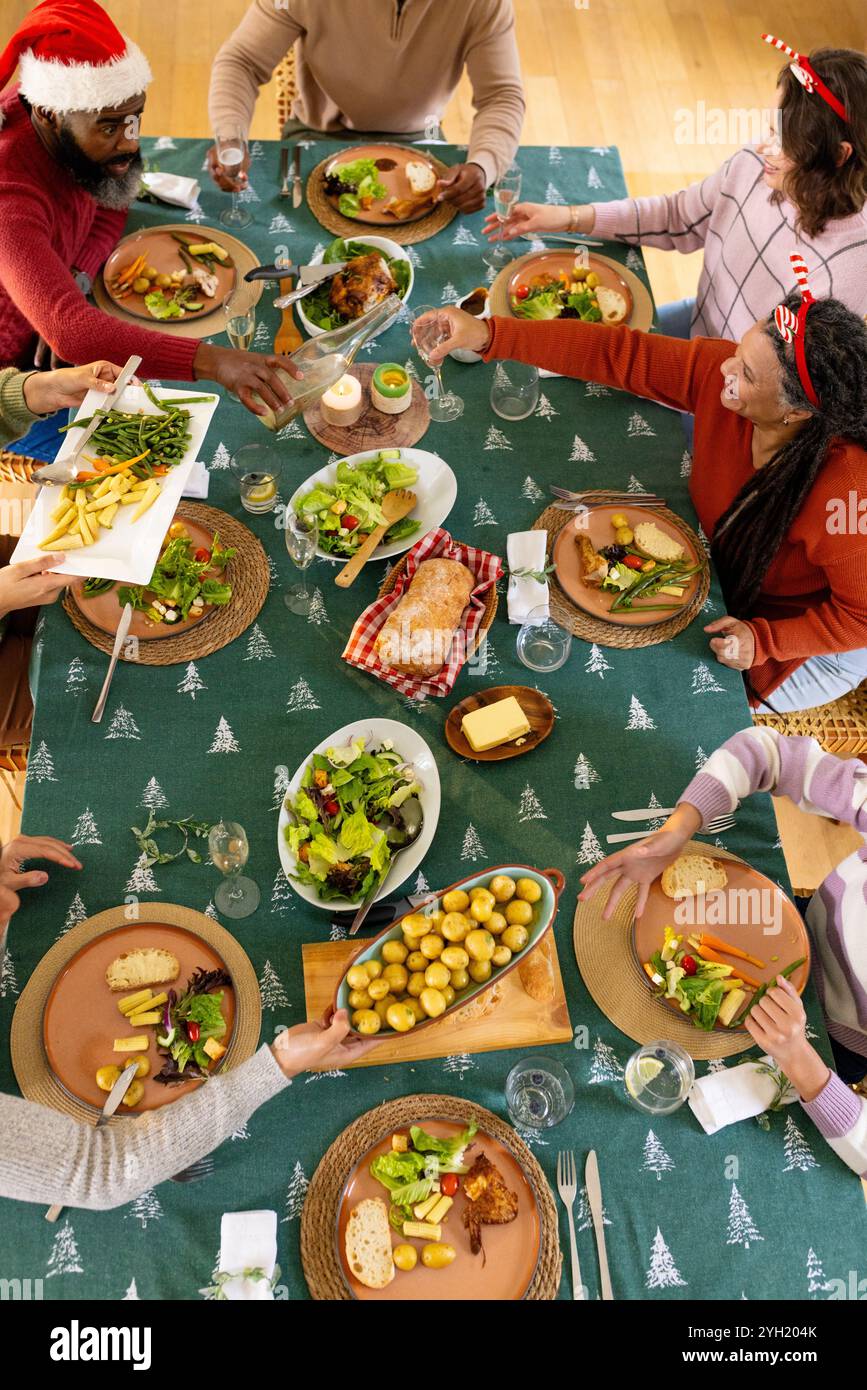Multiracial family enjoying festive christmas dinner, at home Stock ...
