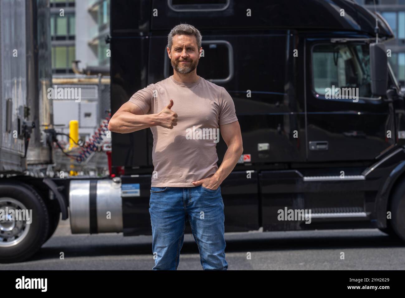 Happy Truck driver. CDL. Portrait of trucker standing by his truck ...