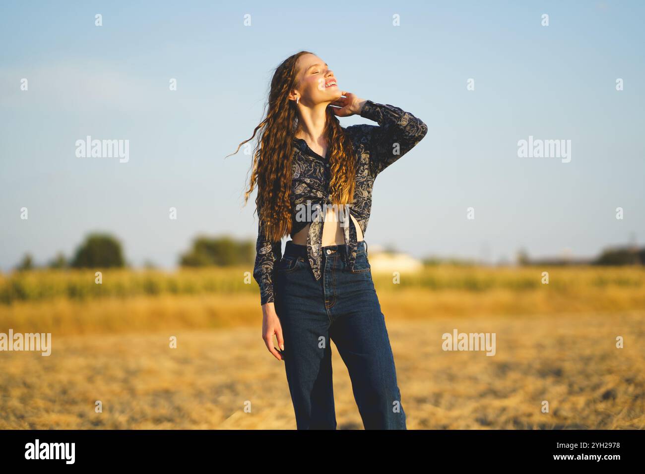 A woman with long flowing hair is joyfully embracing the beauty of ...