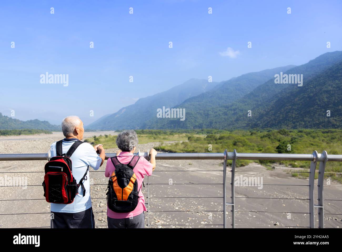 Travel and tourism. Senior family couple walking together on bridge ...