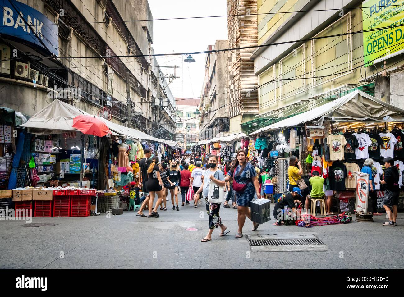 A busy scene at a junction with shoppers and traders at a market in ...