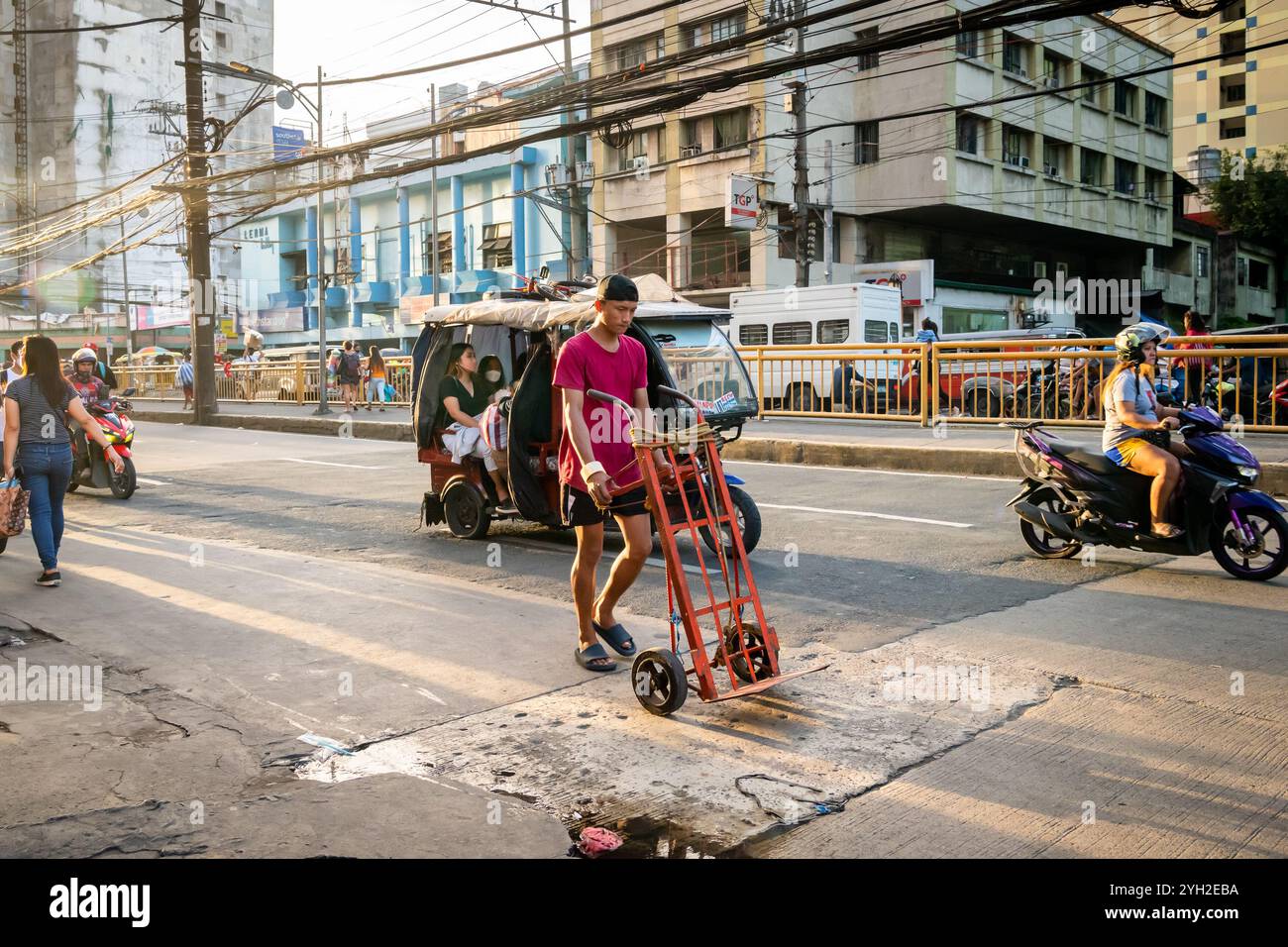 Man pulling trolley hi-res stock photography and images - Alamy