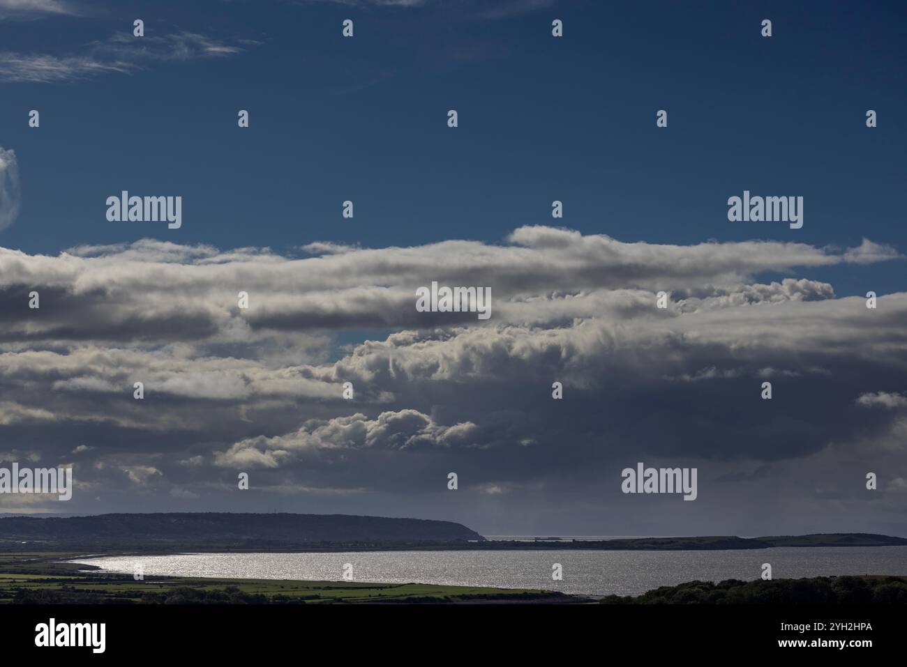 Squally weather over the Severn estuary with cumulus clouds and blue ...