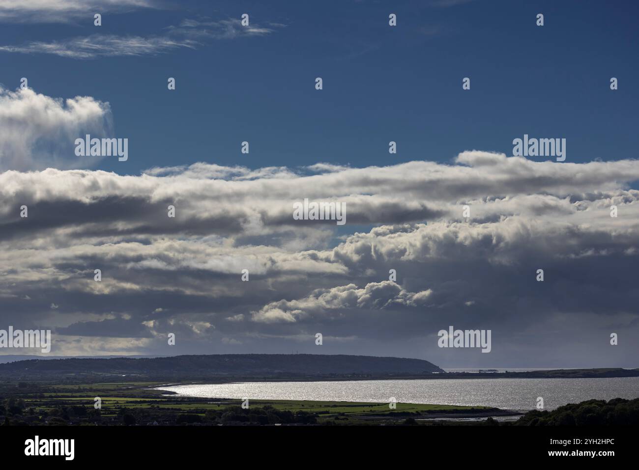 Squally weather over the Severn estuary with cumulus clouds and blue ...