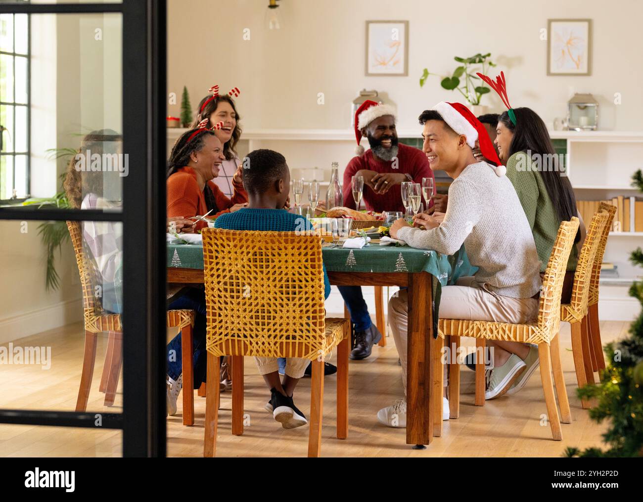 Wearing holiday hats, diverse multiracial family sharing festive ...