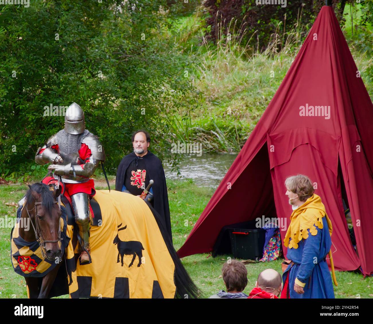 Man in armour riding a caparisoned horse during a historical ...