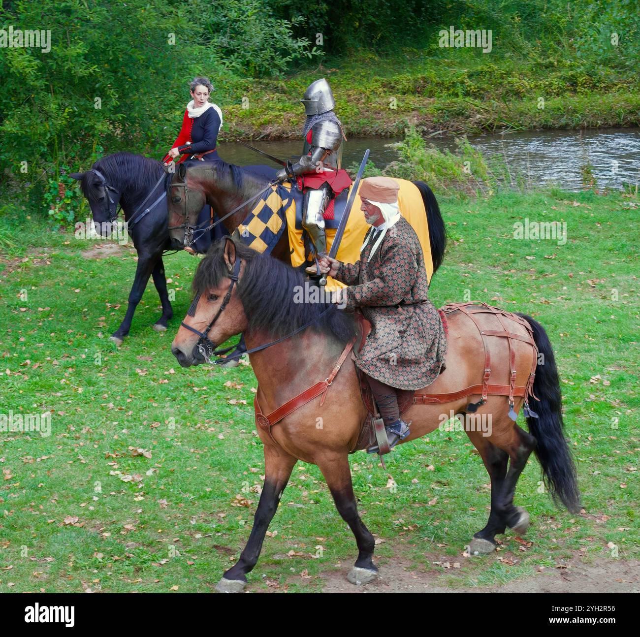 Participants in medieval costumes riding caparisoned horses during a ...