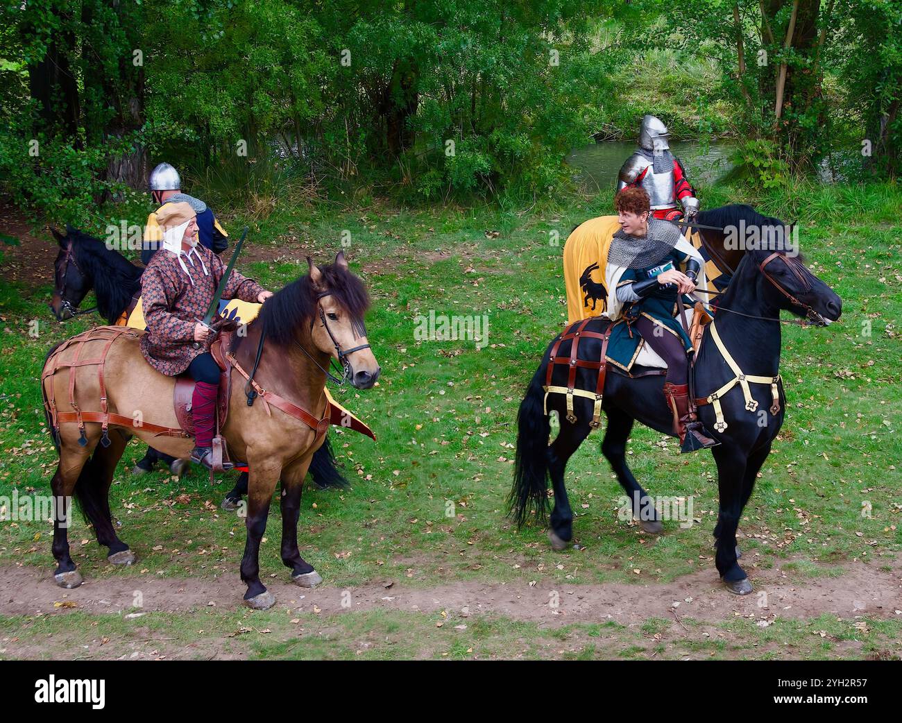 Participants in medieval costumes riding caparisoned horses during a ...