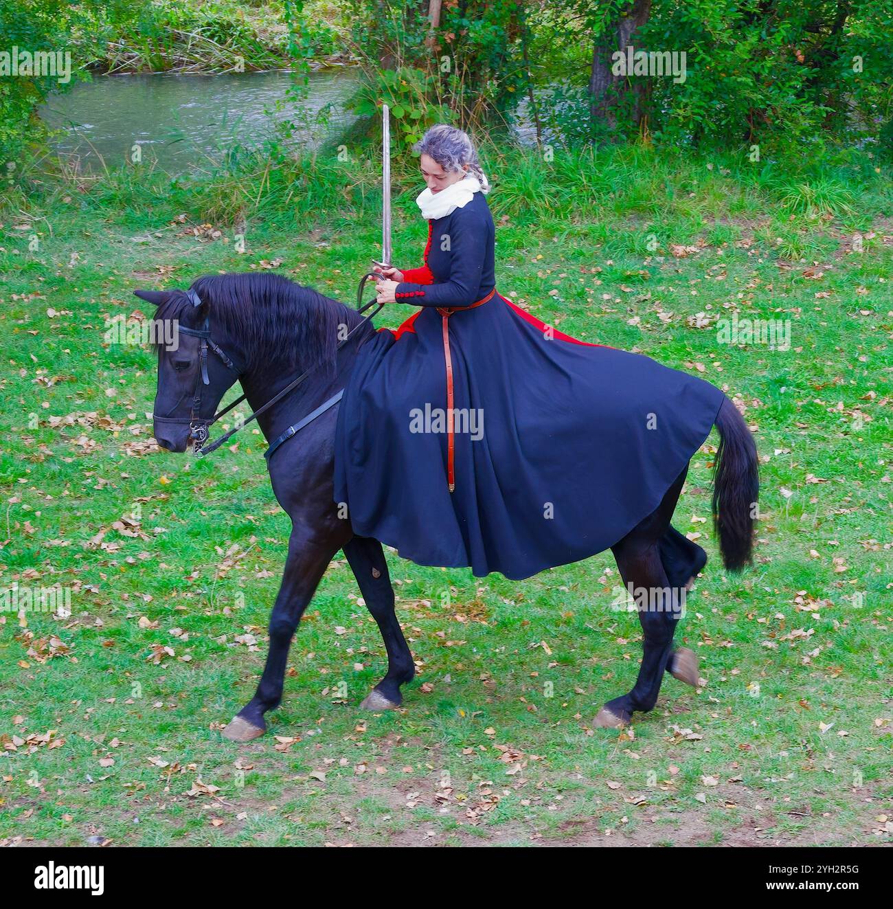 Woman in red dress riding horse hi-res stock photography and images - Alamy