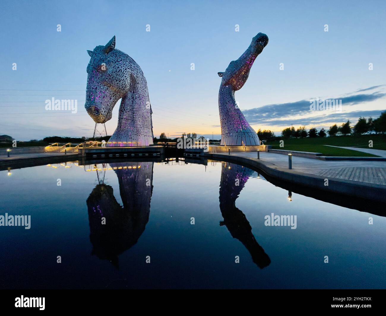 The Kelpies, two large horse-head sculptures, are beautifully reflected ...