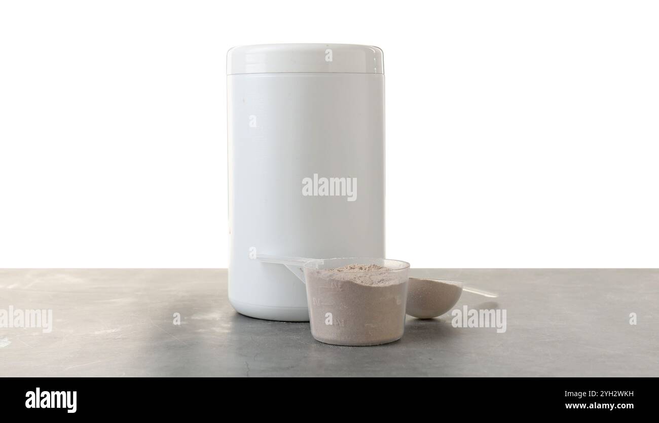 Protein powder on grey table against white background Stock Photo - Alamy