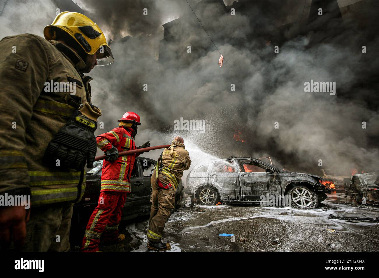 09 November 2024, Lebanon, Beirut: Firefighters extinguish the flames ...