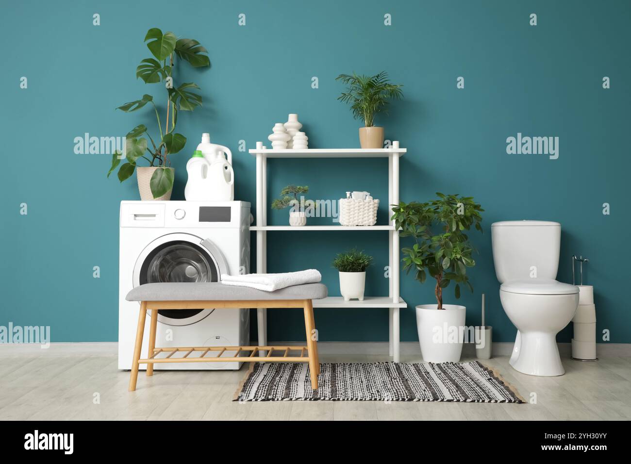 Interior of stylish bathroom with washing machine, toilet bowl and grey ...