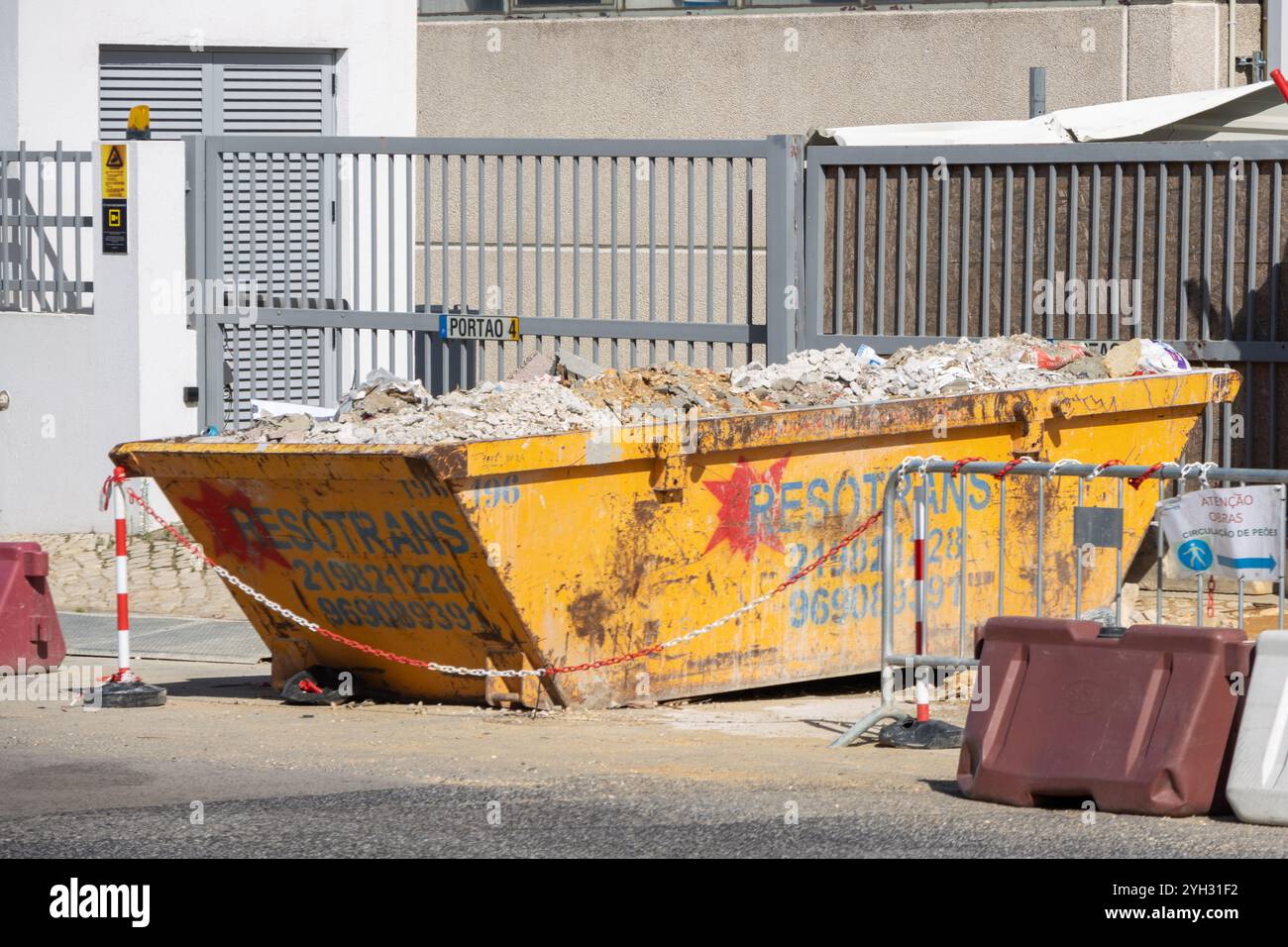 Overflowing skip bin containing construction and demolition waste ...