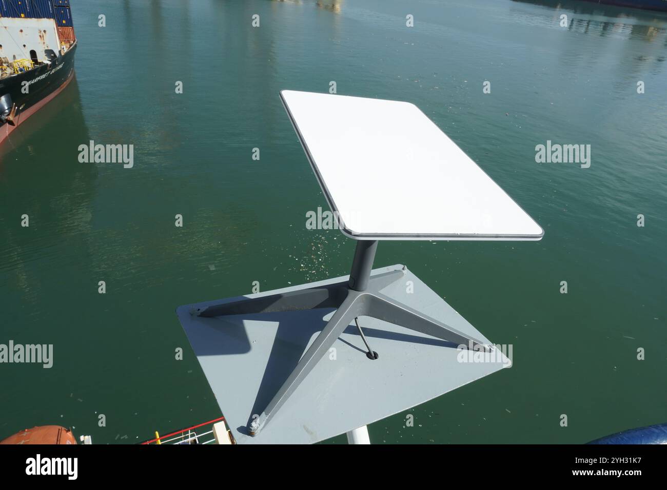 Starlink antenna mounted on the wing of the bridge of a container ship ...