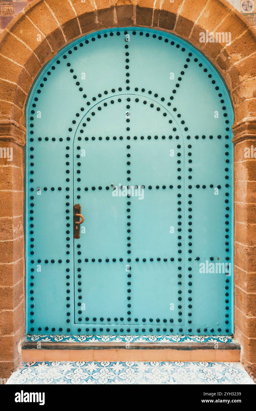 Traditional decorative Moroccan arched blue extrerior door with ornate ...
